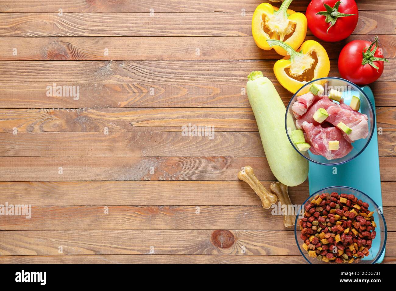 Dry and fresh pet food on wooden background Stock Photo - Alamy