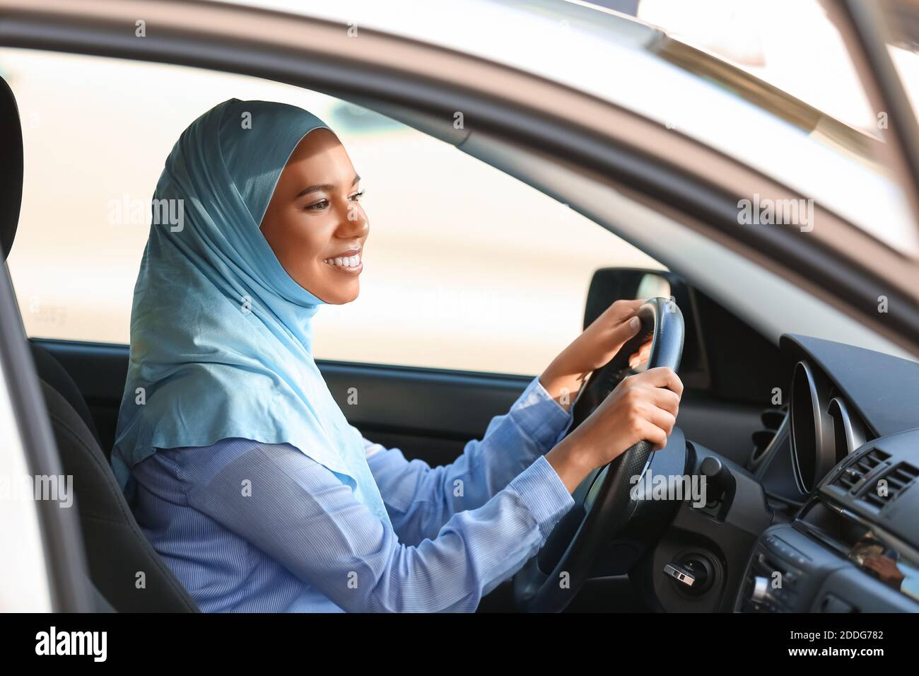 Young Muslim woman driving car Stock Photo - Alamy