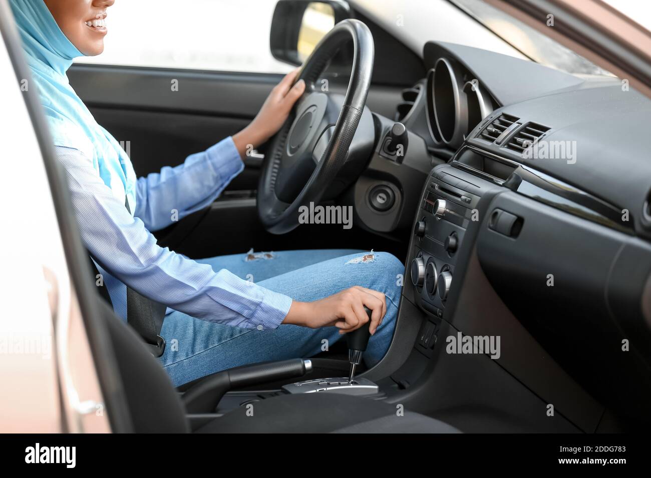 Young Muslim woman driving car Stock Photo - Alamy