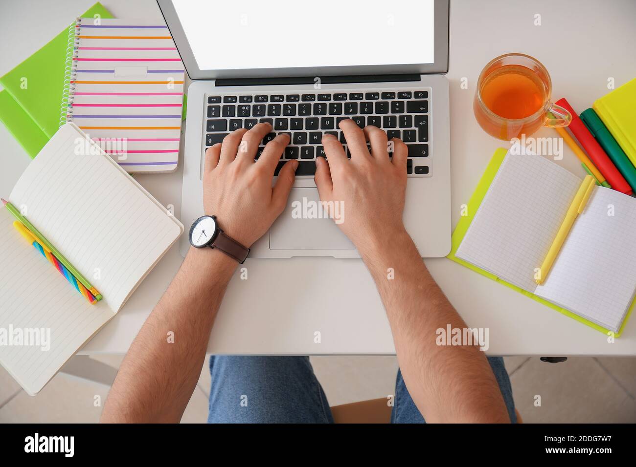 Young man working on laptop in office, top view Stock Photo - Alamy