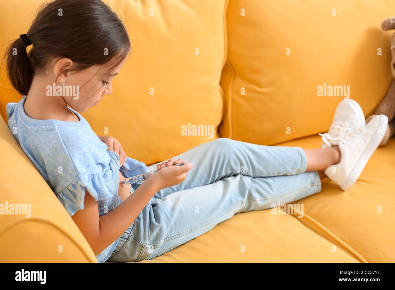 Little diabetic girl giving herself insulin injection at home Stock ...