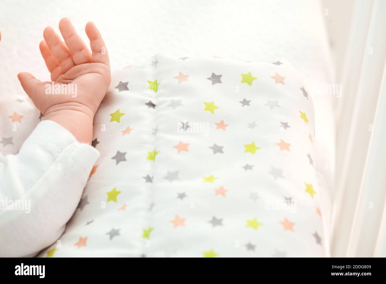 Hand of cute little baby lying on bed Stock Photo - Alamy