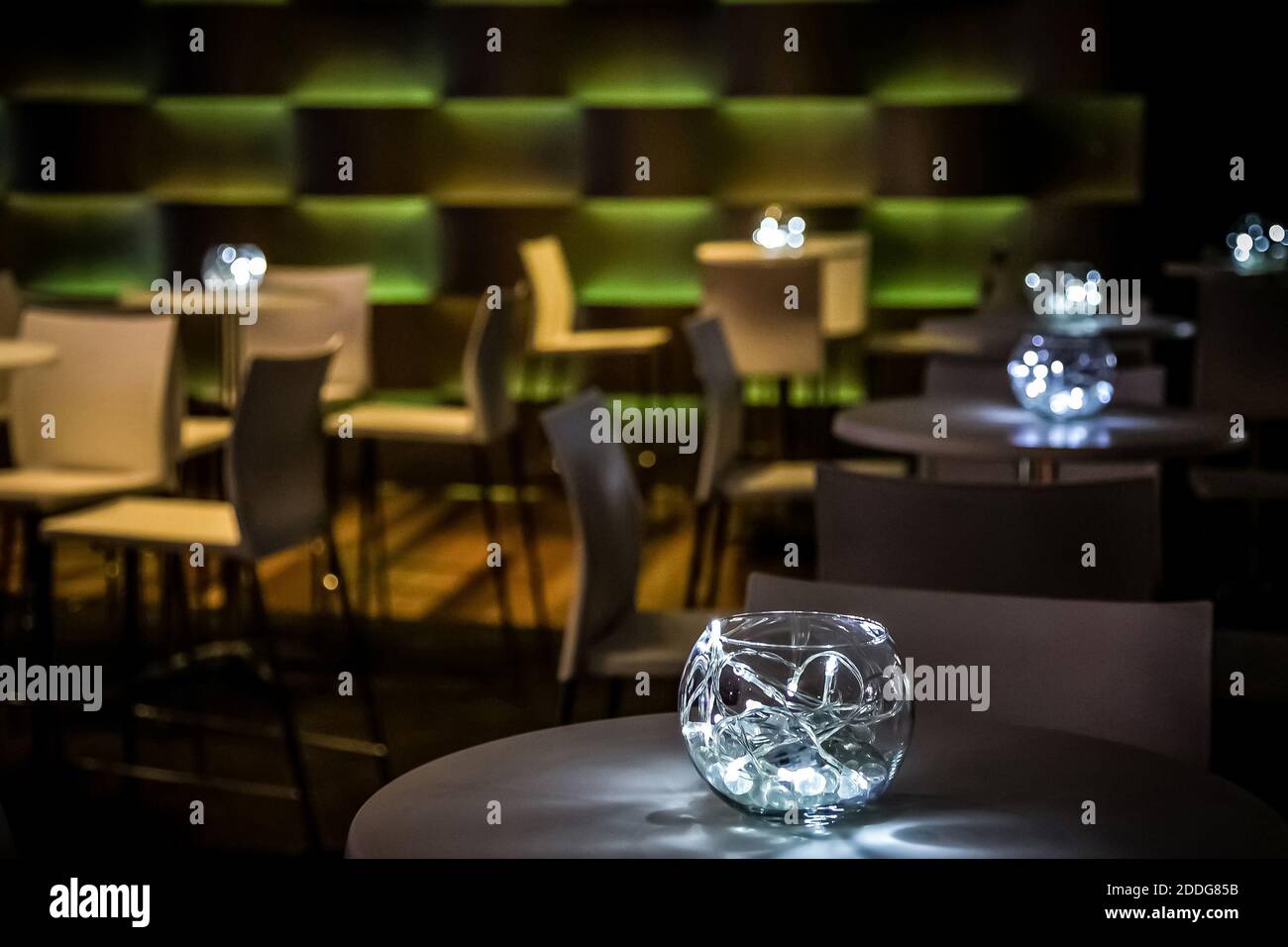 A beautiful interior decoration with glass tanks with fairy lights on ...