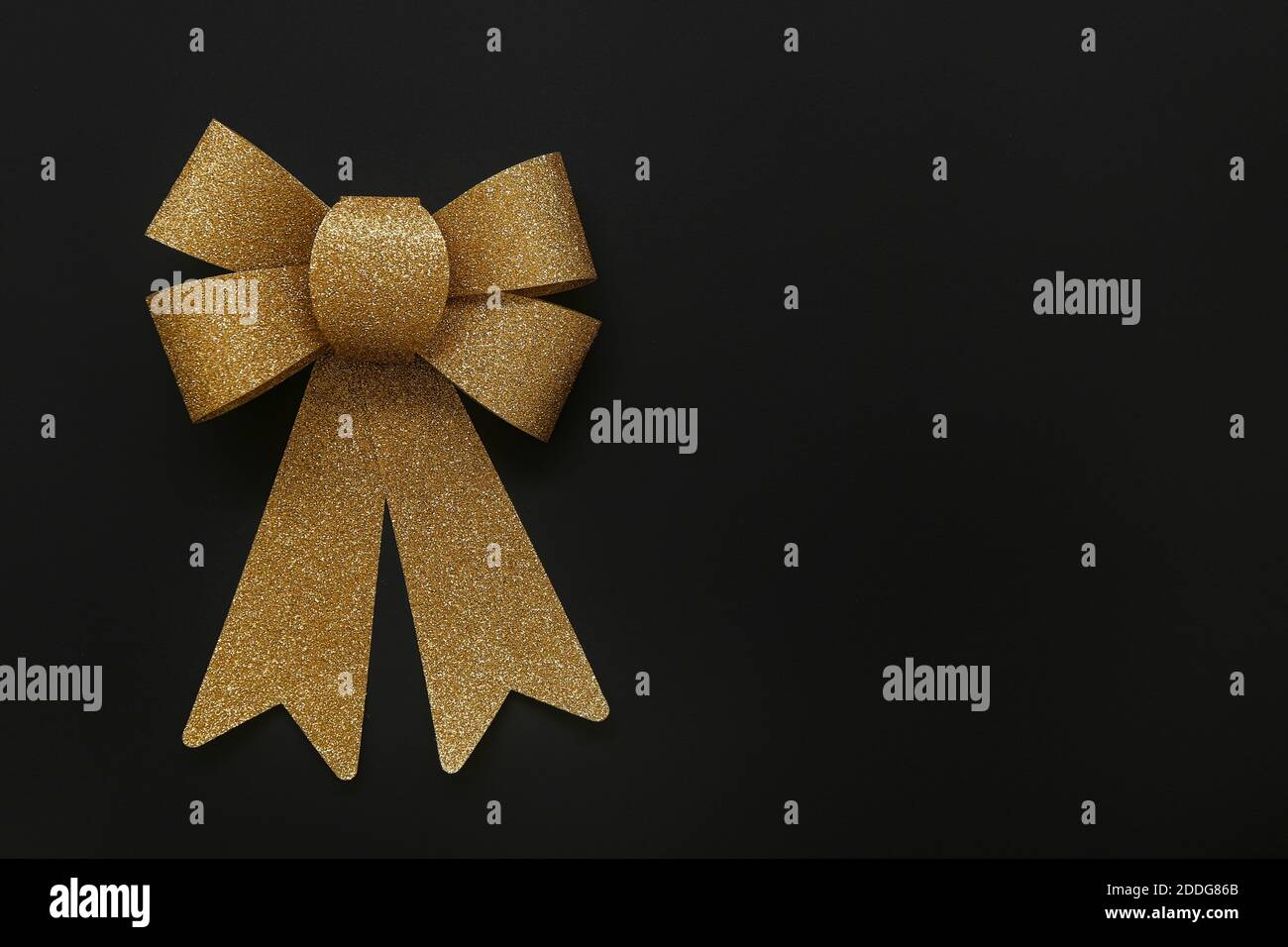 Golden bow on dark background Stock Photo - Alamy
