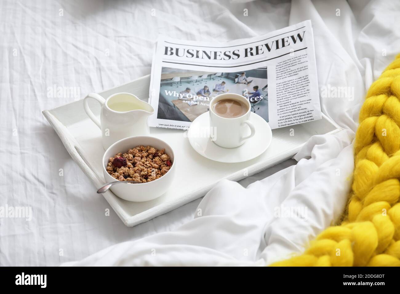 Tray with tasty breakfast and newspaper on bed Stock Photo - Alamy