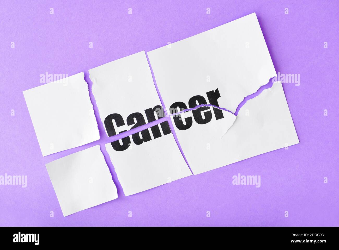 Torn paper sheet with word CANCER on color background Stock Photo - Alamy