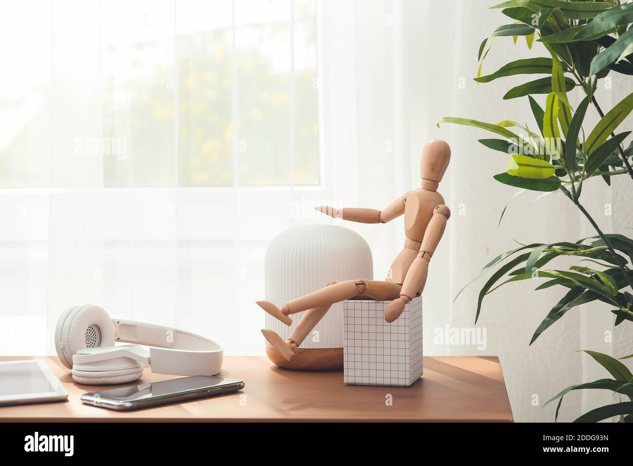 Wooden mannequin with modern devices on table in room Stock Photo - Alamy