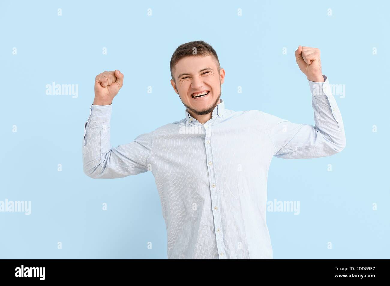 Handsome happy young man on color background Stock Photo - Alamy