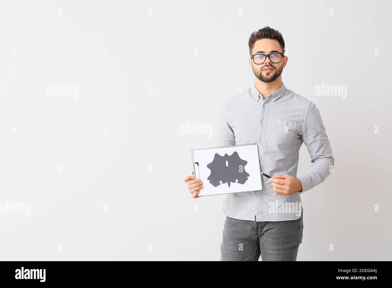 Portrait of male psychologist on light background Stock Photo - Alamy