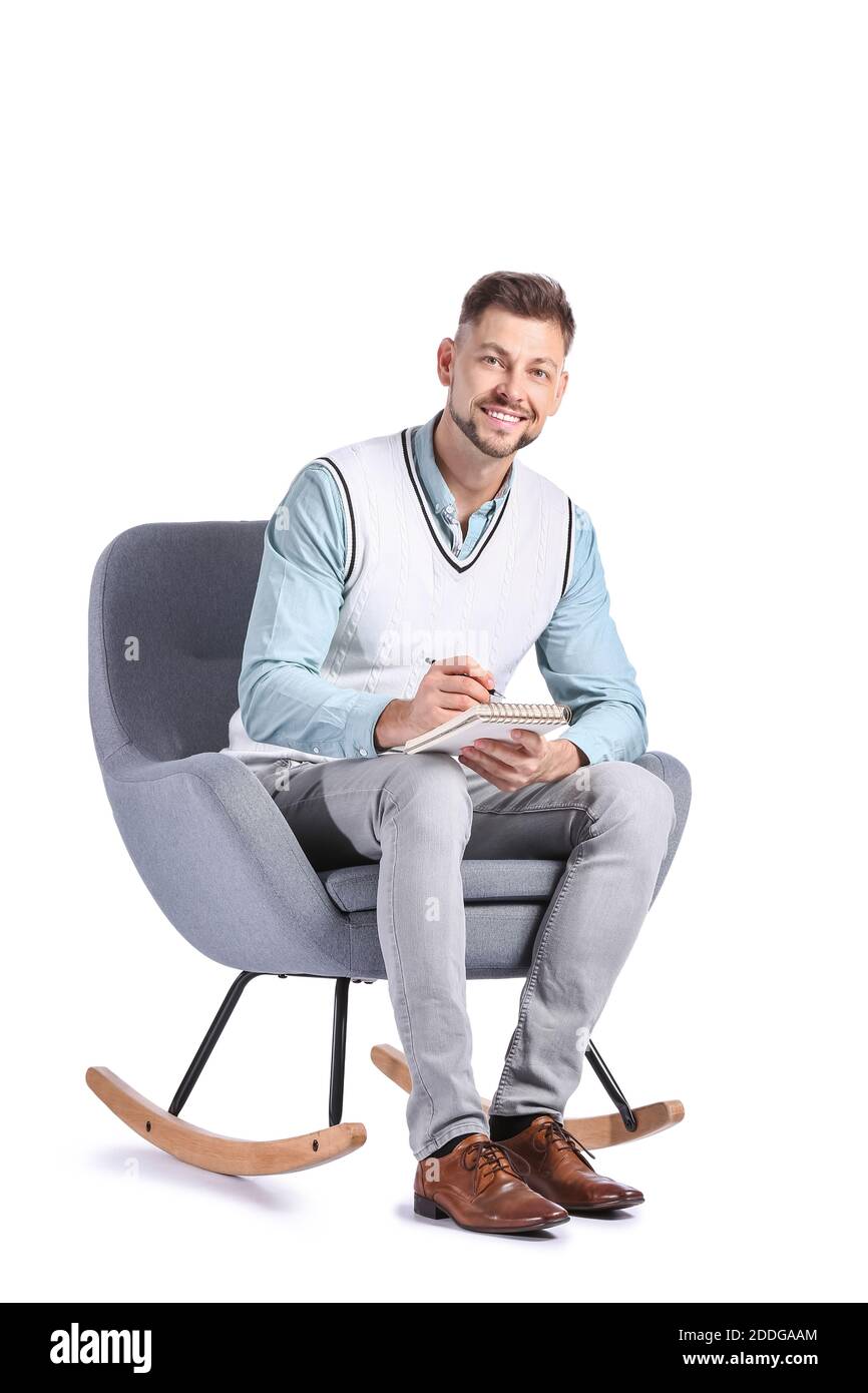 Male psychologist sitting in armchair on white background Stock Photo ...