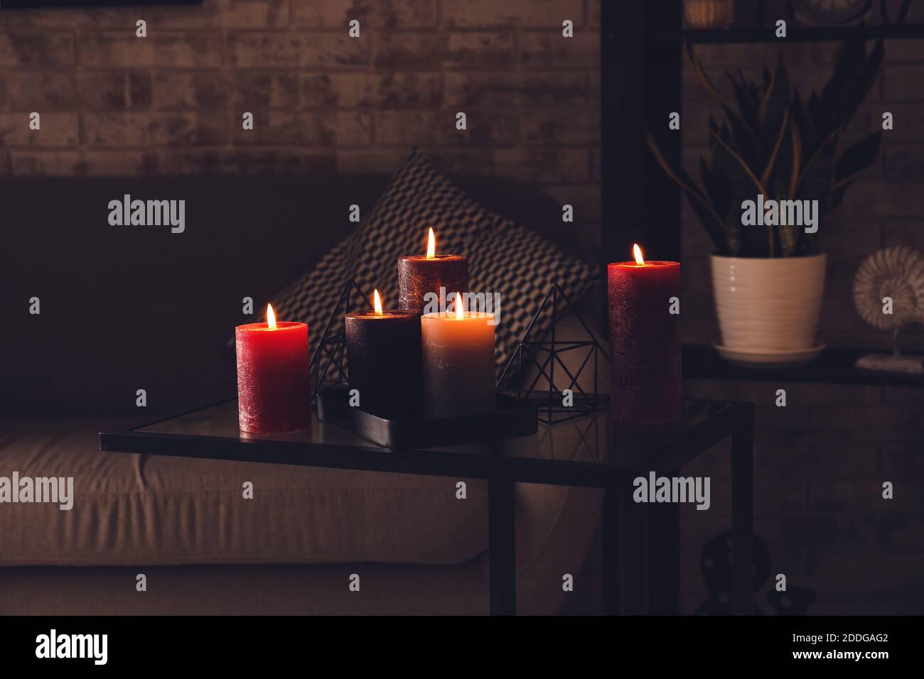 Beautiful aroma candles on table in dark room Stock Photo - Alamy
