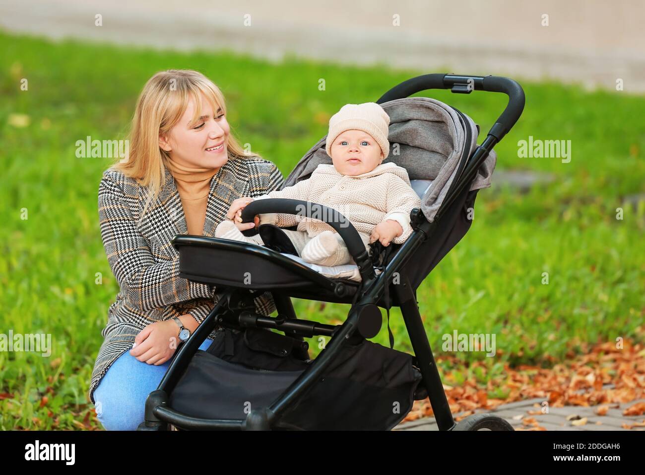 Woman and her cute baby in stroller outdoors Stock Photo - Alamy