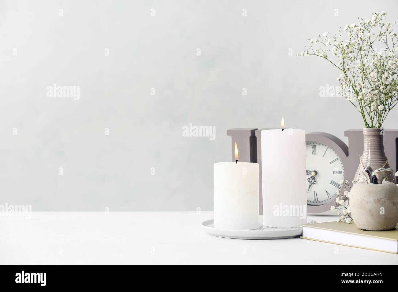 Beautiful aroma candles on table in room Stock Photo - Alamy
