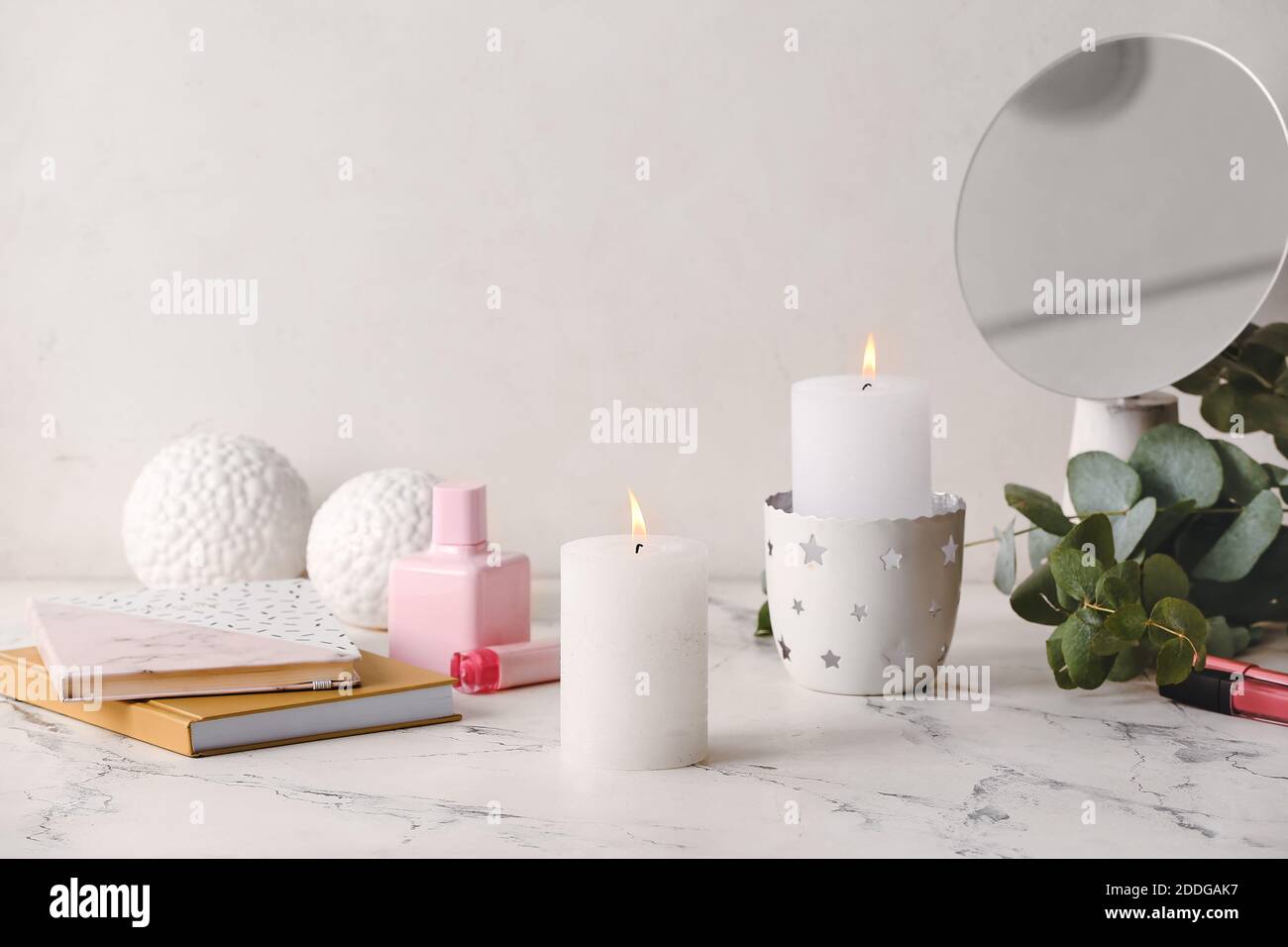 Beautiful aroma candles on dressing table in room Stock Photo - Alamy