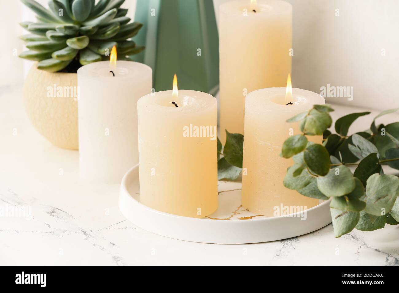 Beautiful aroma candles on table in room Stock Photo - Alamy