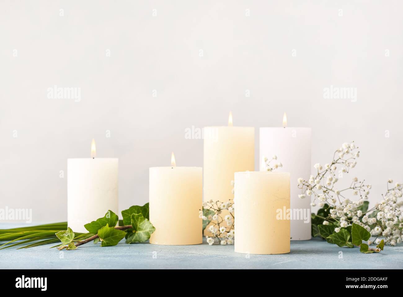 Beautiful aroma candles on table in room Stock Photo - Alamy