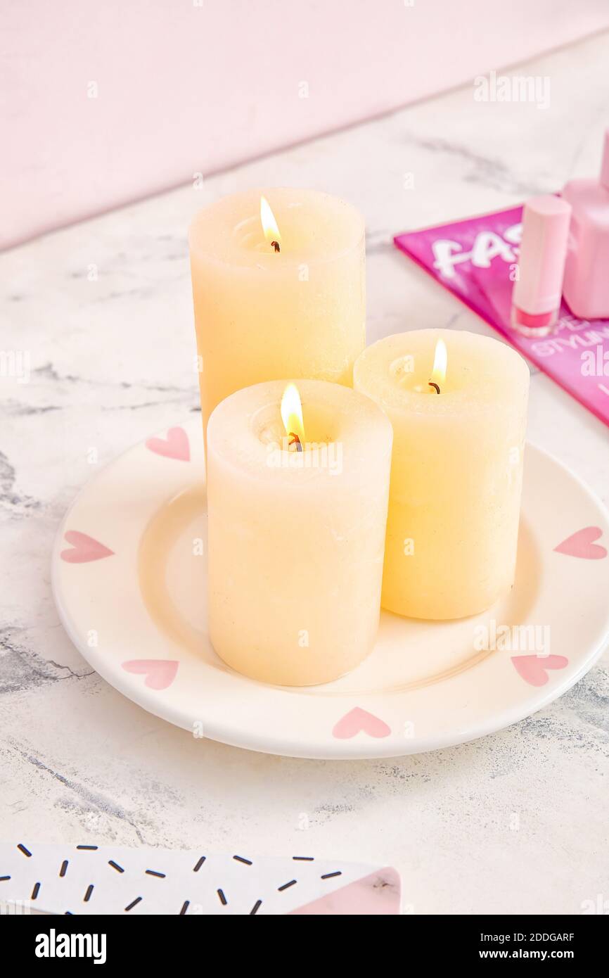 Beautiful aroma candles on table in room Stock Photo - Alamy