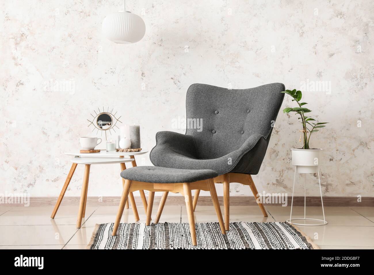 Stylish interior of living room with armchair Stock Photo - Alamy