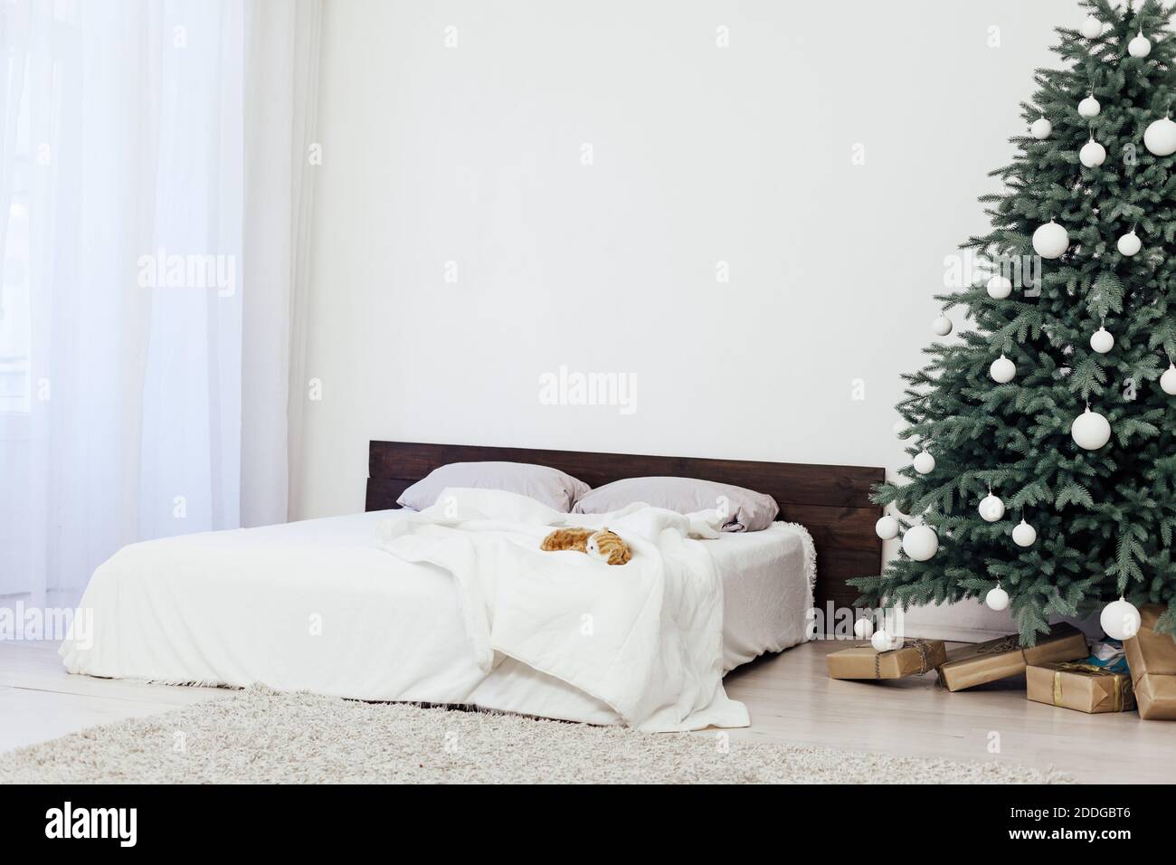 New year bedroom decor with Christmas tree bed with gifts and garlands ...