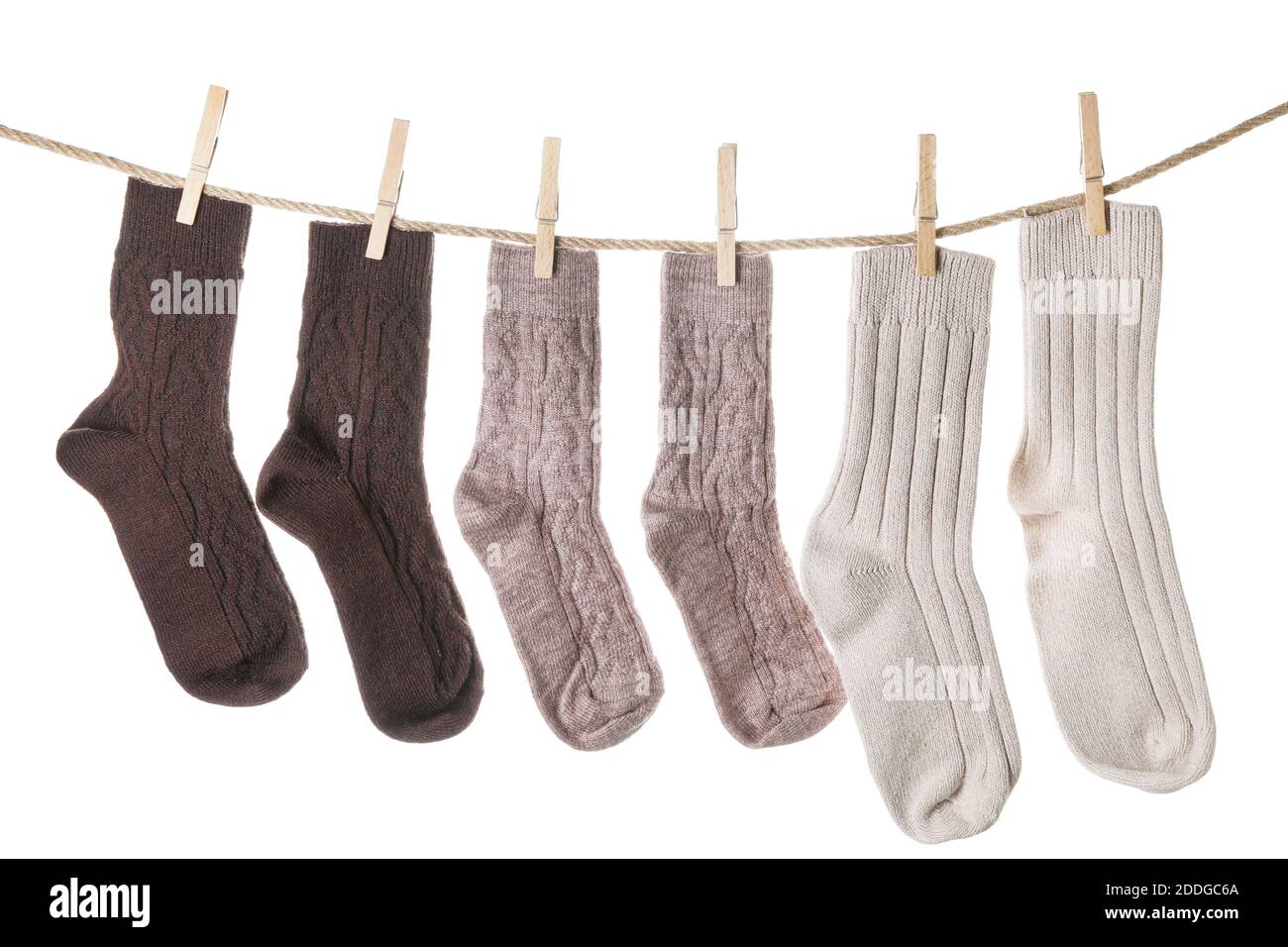 Warm socks hanging on clothes line against white background Stock Photo ...