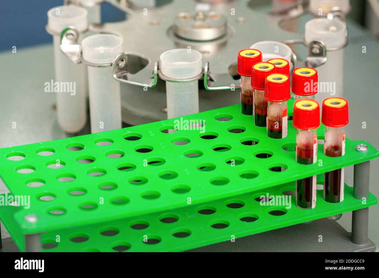Test tubes with blood samples in rack and in centrifuge machine in the ...