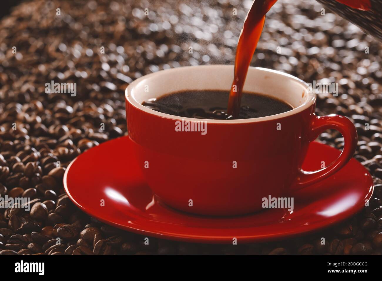 Pouring of hot coffee in cup, closeup Stock Photo - Alamy