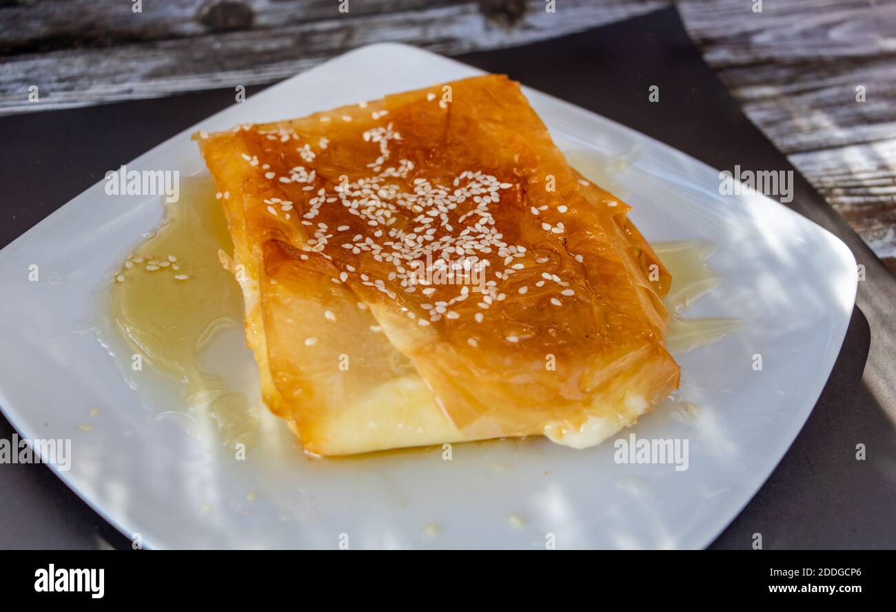 Saganáki, σαγανάκι, feta cheese baked in sesame puff pastry Stock Photo ...