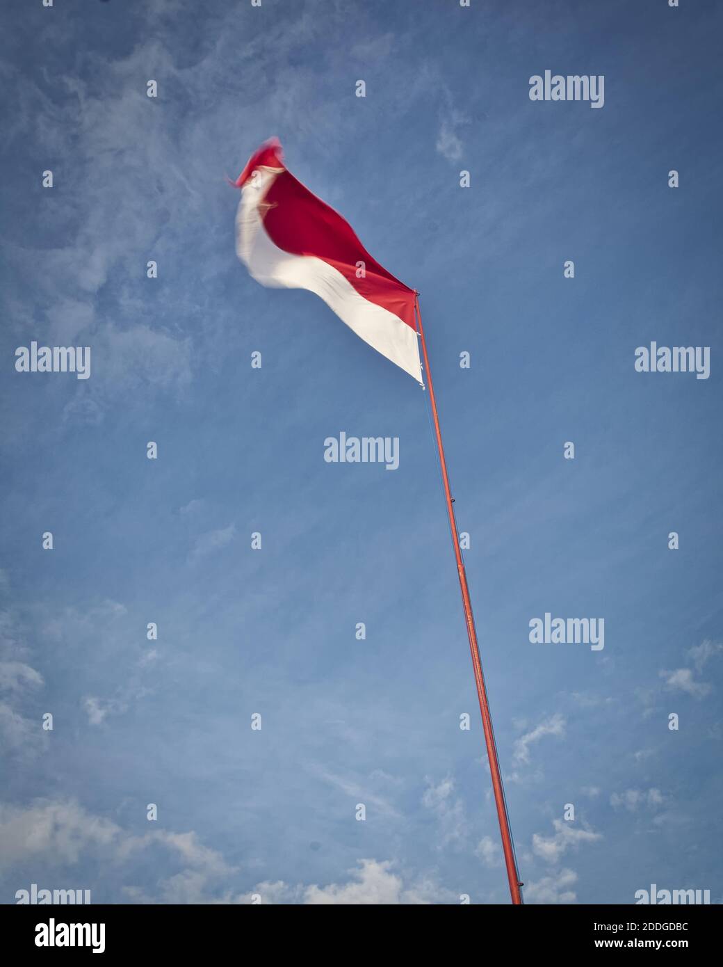 A vertical low angle shot of the Indonesian flag Stock Photo - Alamy