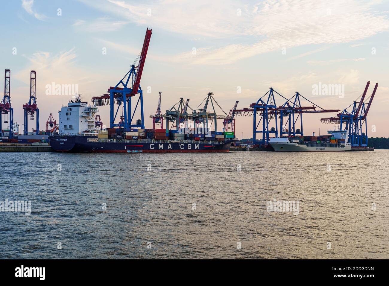 Gorgeous seaside view of the container harbor in Hamburg with cranes ...