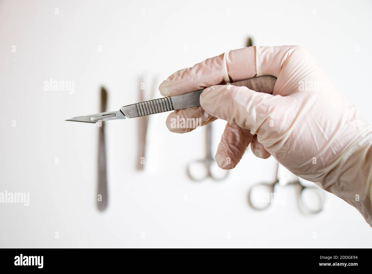 Surgery knife holding on the white background, studio shot. Operation ...