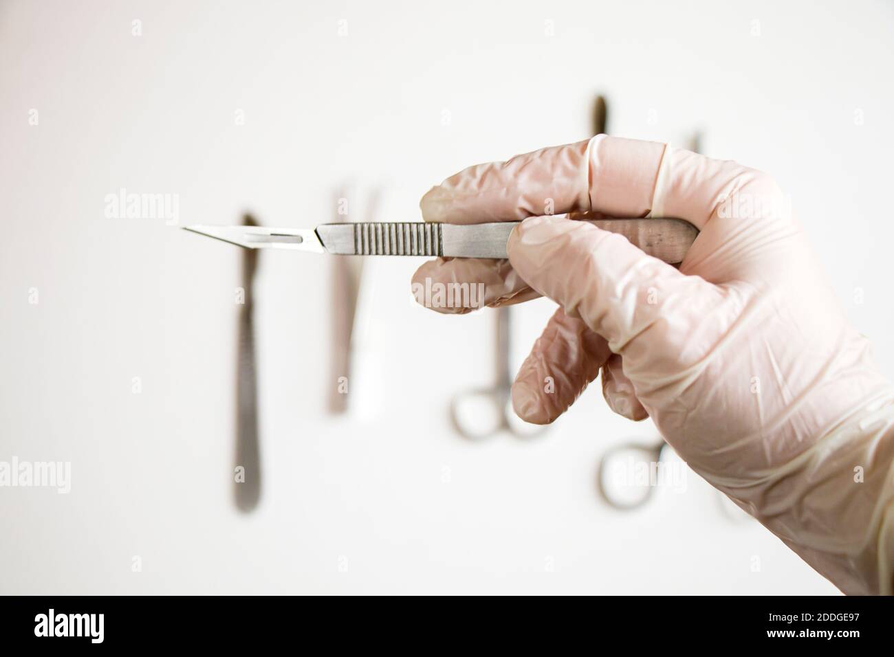 Surgery knife holding on the white background, studio shot. Operation ...