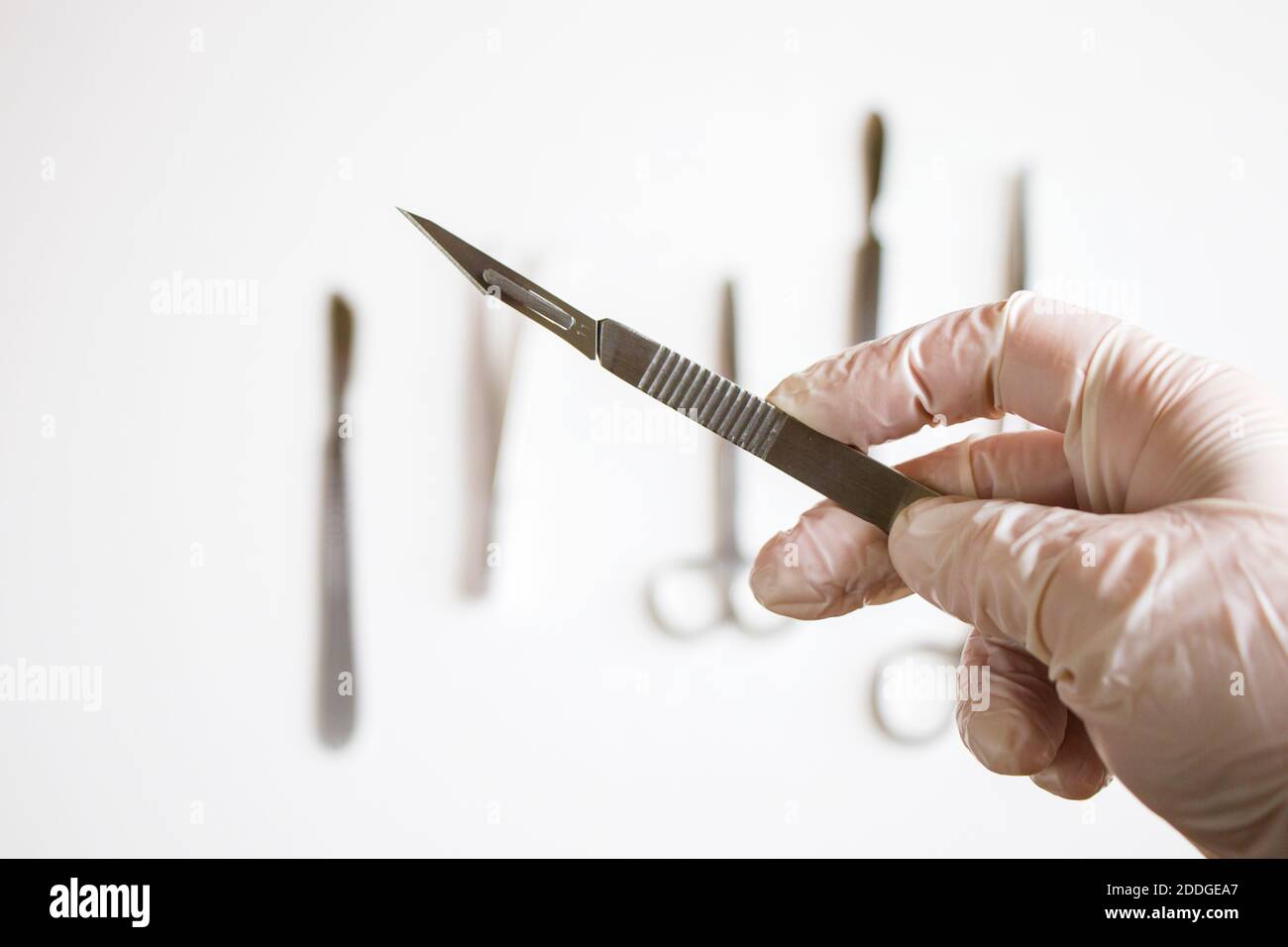 Surgery knife holding on the white background, studio shot. Operation ...