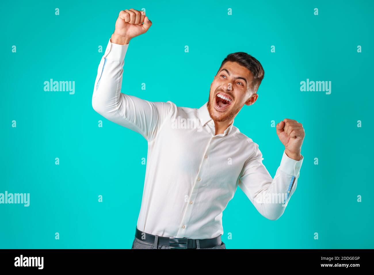Portrait of excited, successful man raising hands up Stock Photo - Alamy