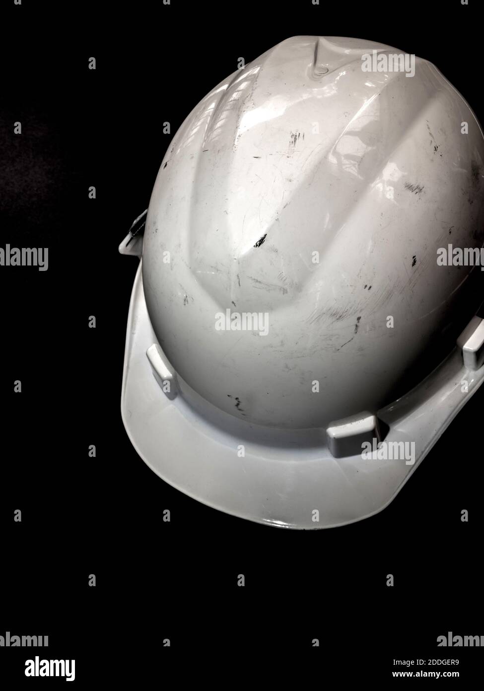 Scratched on the Old Safety helmet on black background Stock Photo - Alamy