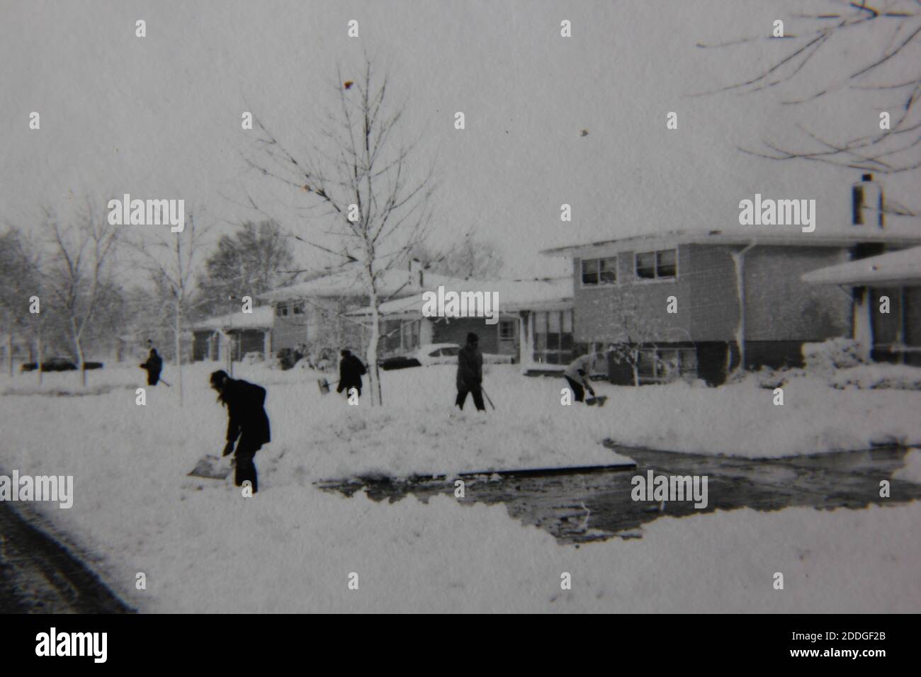 Fine 1970s vintage black and white photography of people shoveling snow ...