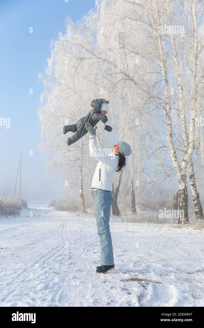 Happy mother and baby is playing on a winter nature walk, Siberia ...