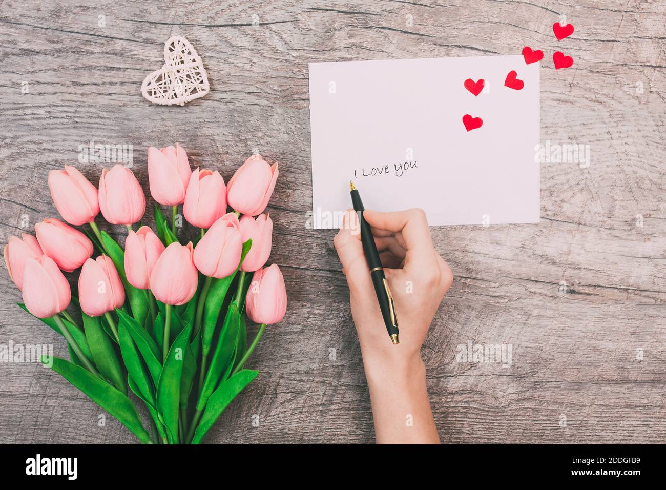 Female hands writing on white paper, an envelope and a beautiful ...