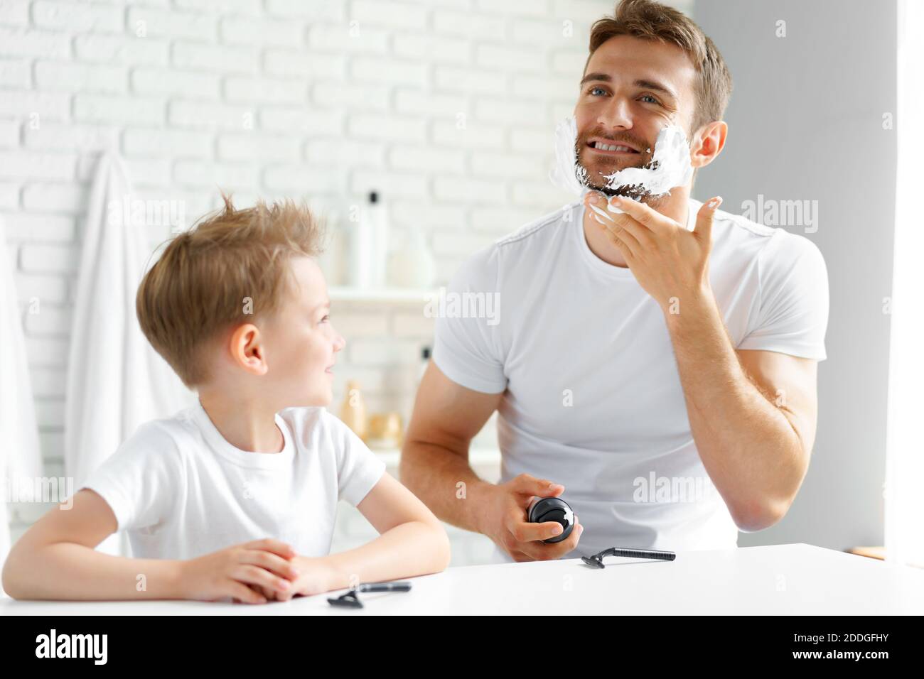 Father teaches his little son how to shave face Stock Photo - Alamy