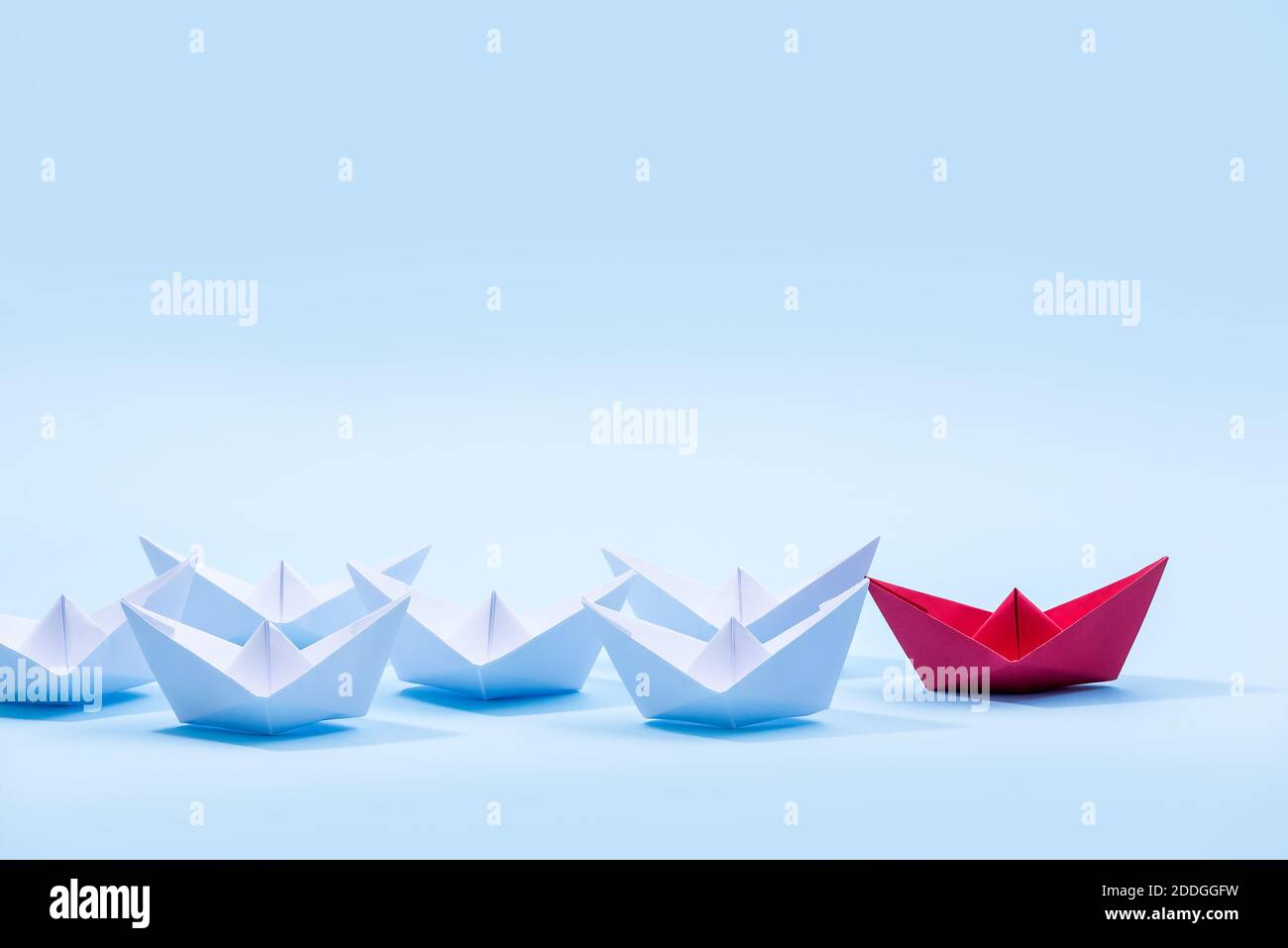 Red and white paper boats. Concept of leadership boats for teamwork ...