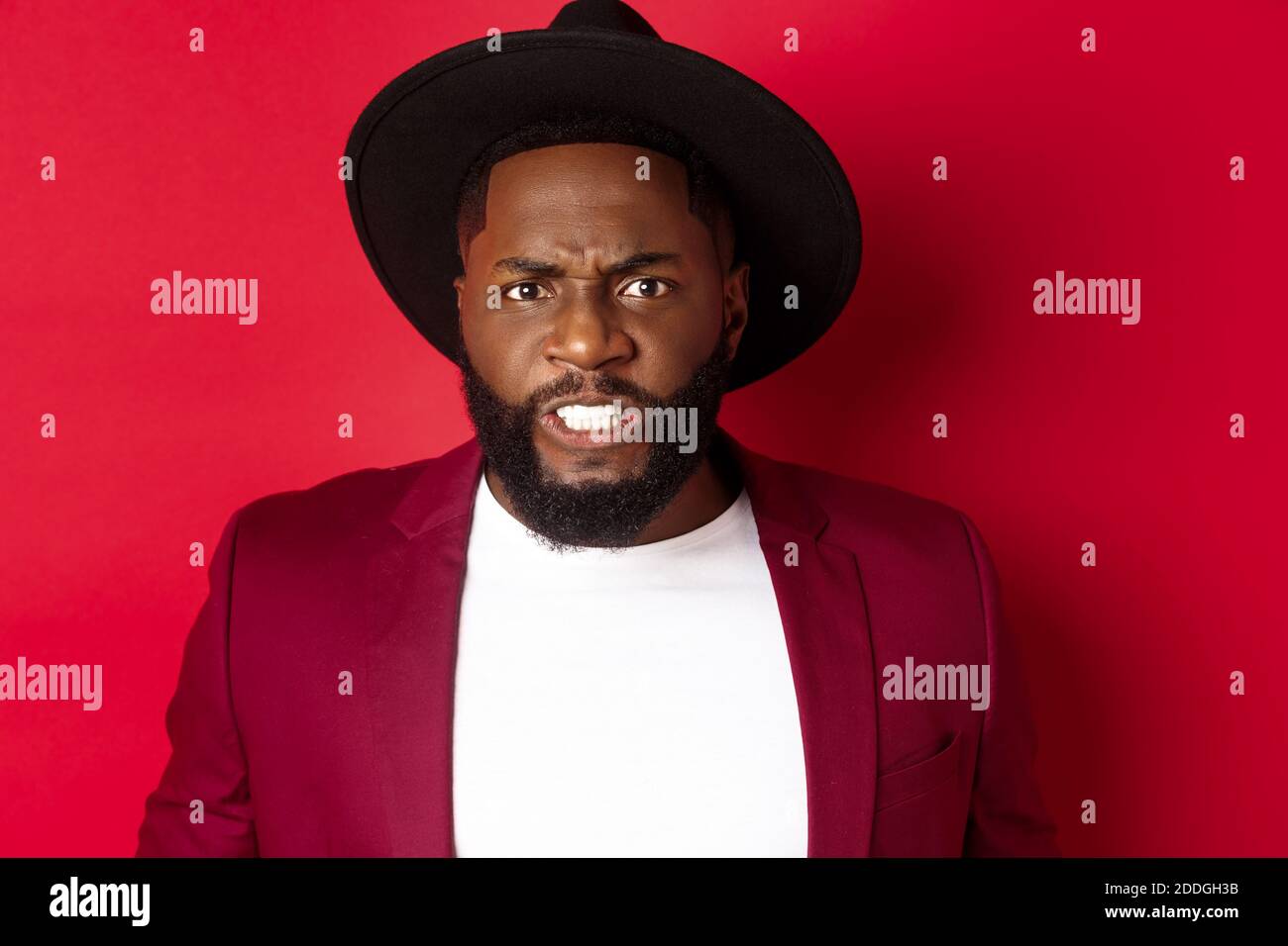 Tensed african american man clench teeth and frowning, looking at ...