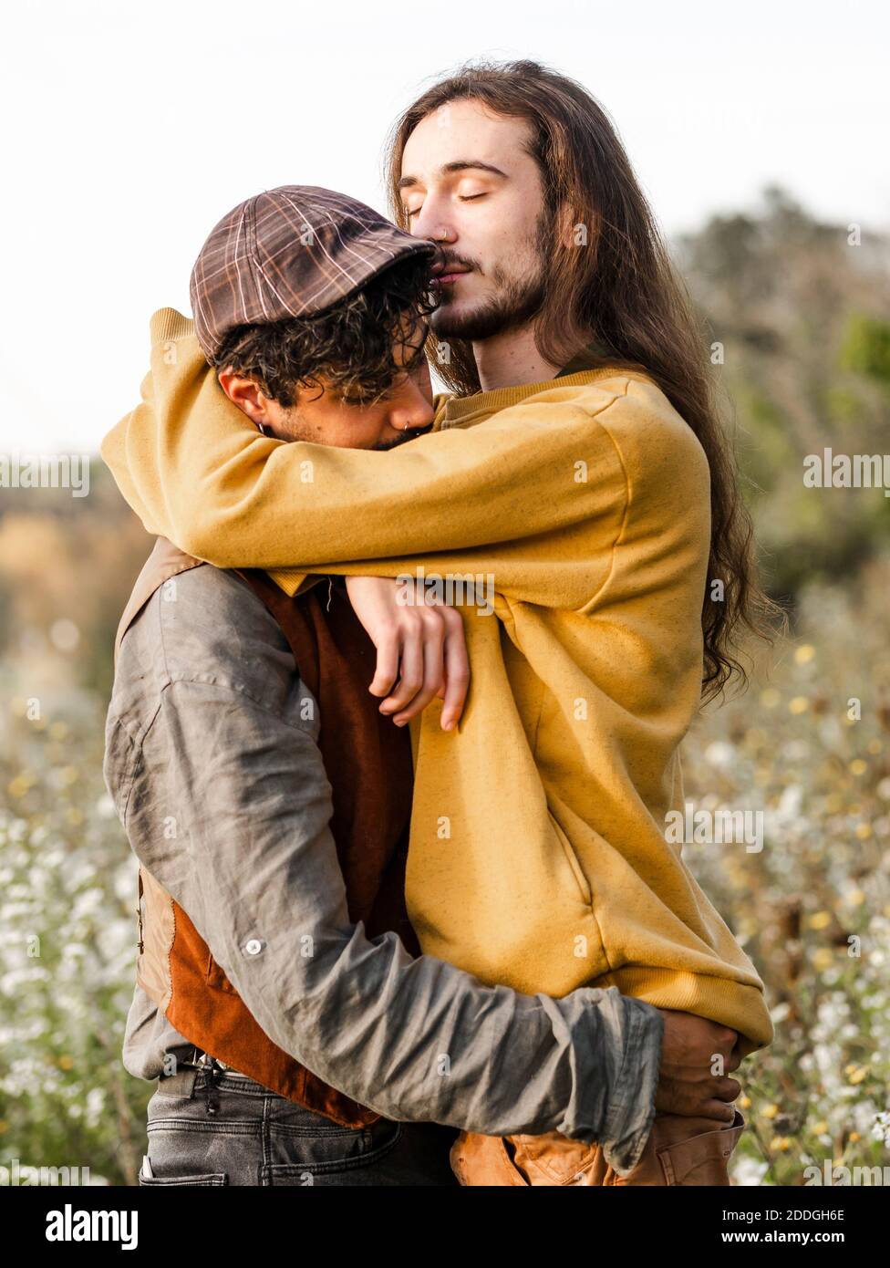 Passionate young ethnic boyfriends embracing each other while having ...