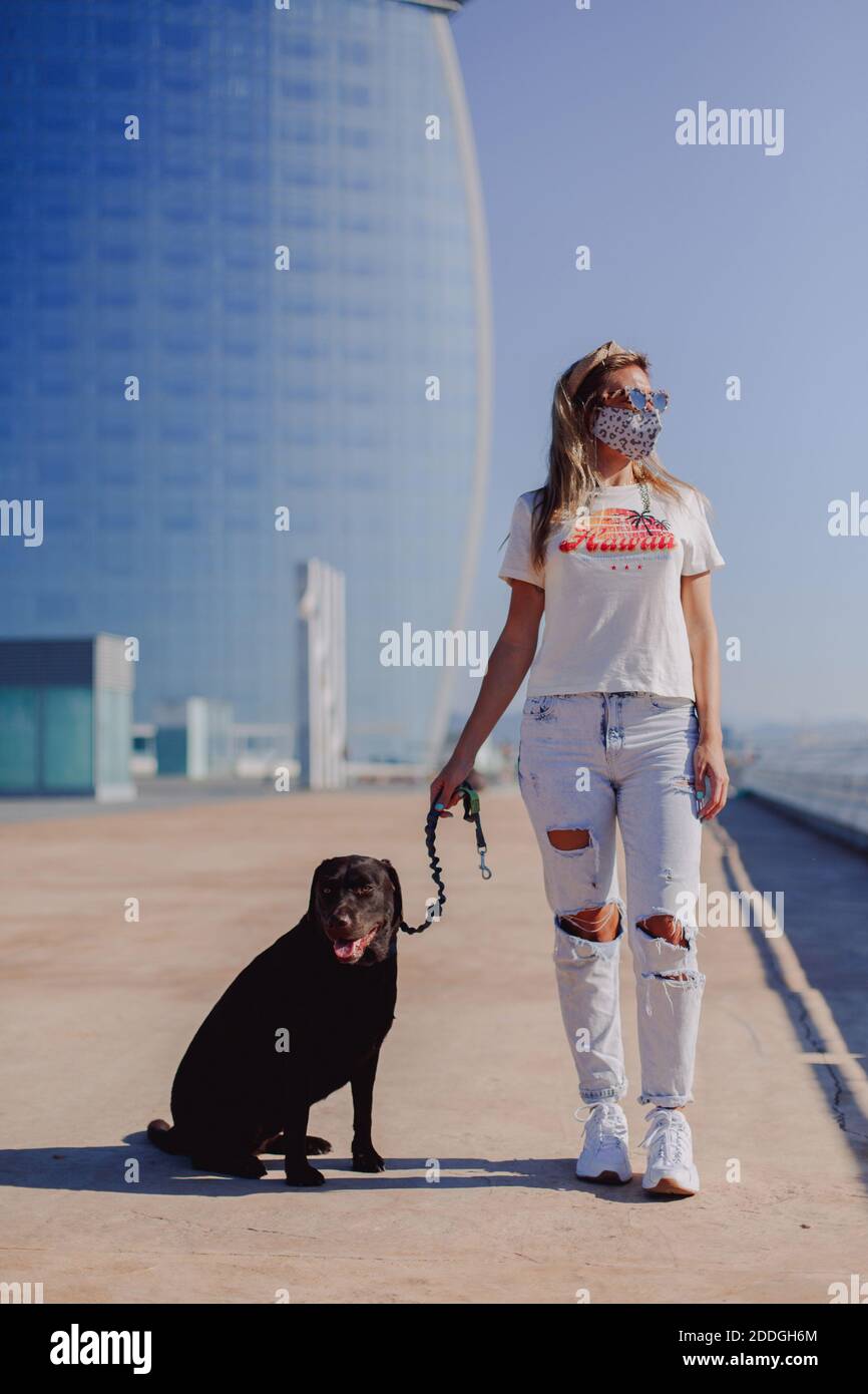 Side view of young African American female in protective mask and ...