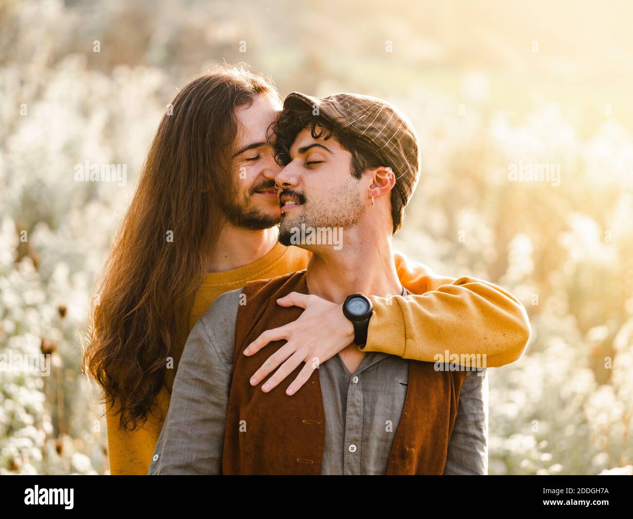 Passionate young ethnic boyfriends embracing each other while having ...