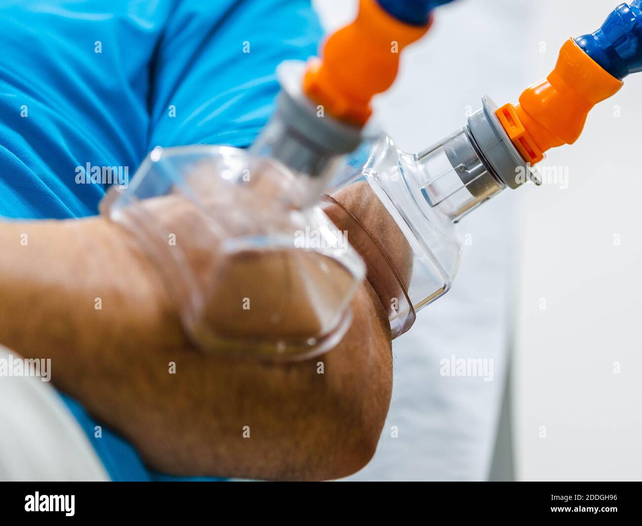 Unrecognizable male patient with vacuum cups on arm sitting on bench ...