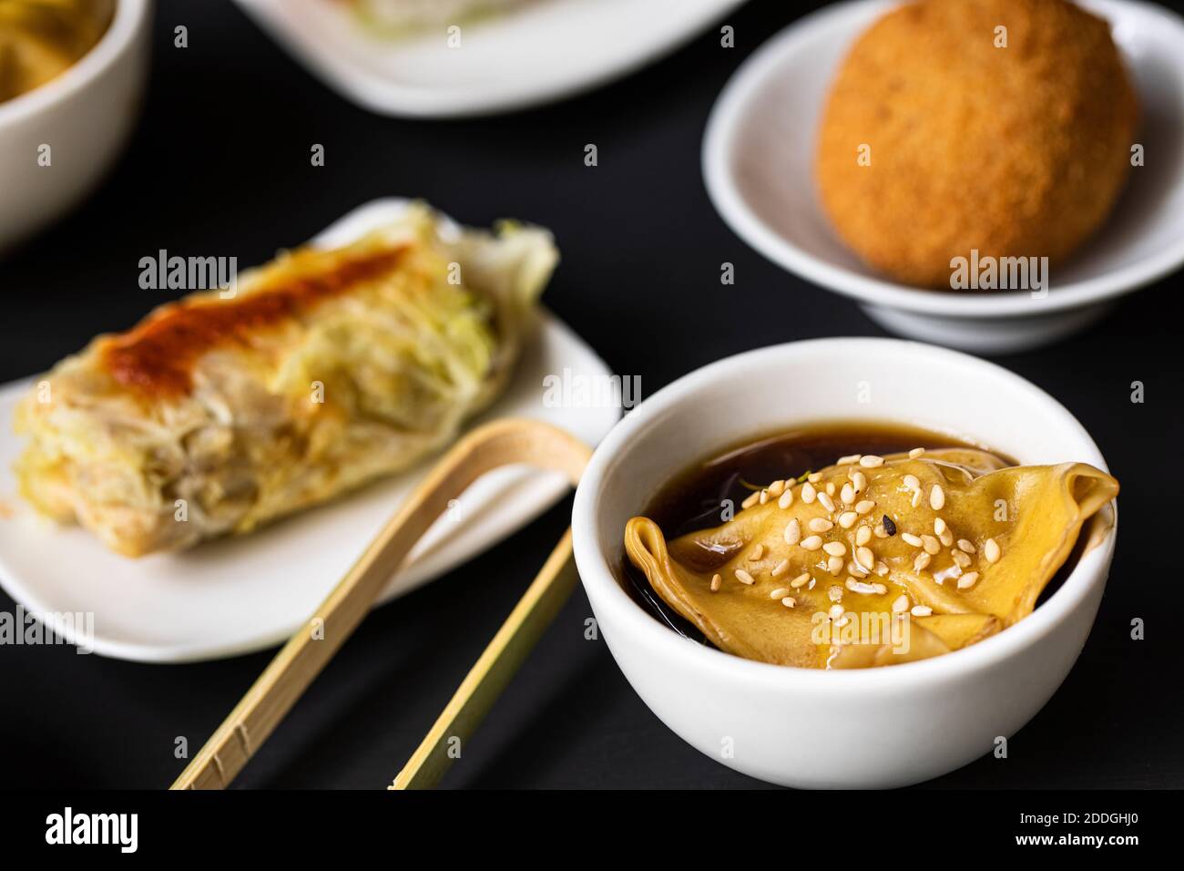 Top view of various tasty fusion food arranged on black table in ...