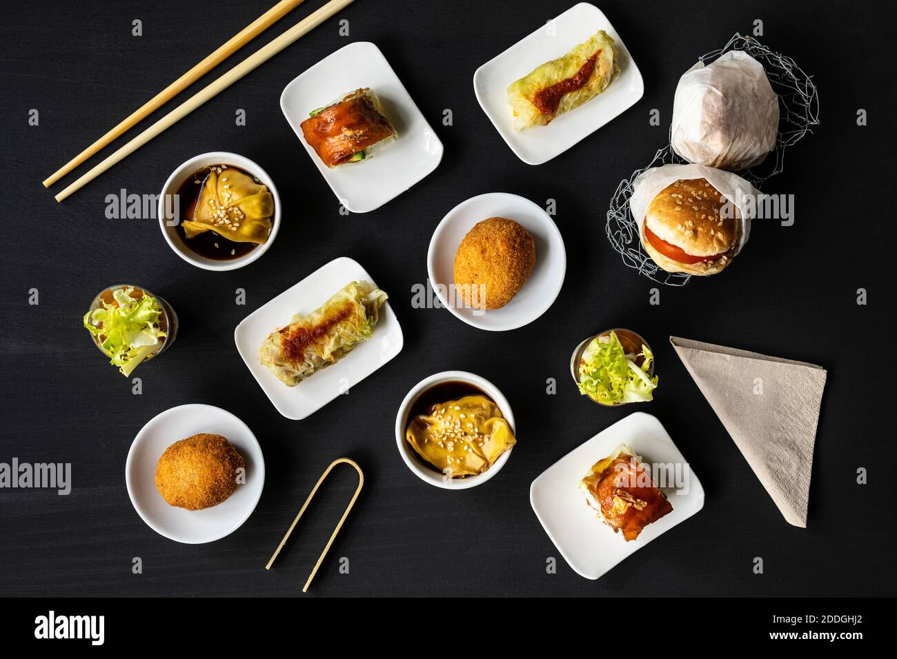 Top view of various tasty fusion food arranged on black table in ...