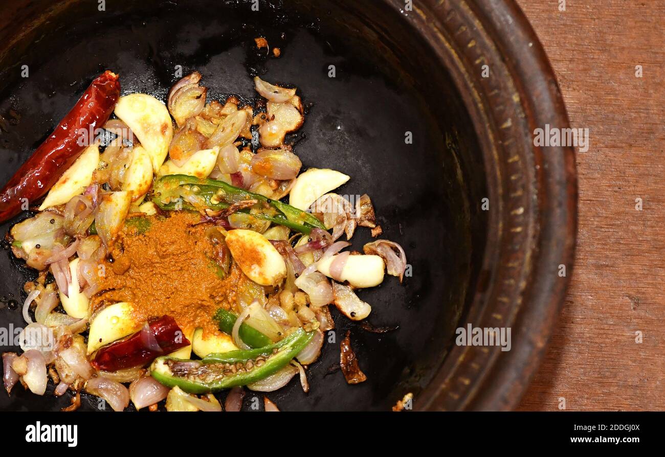 Sautéing or sautéing in a Mud Pan Frying garlic,turmeric,onions,green ...