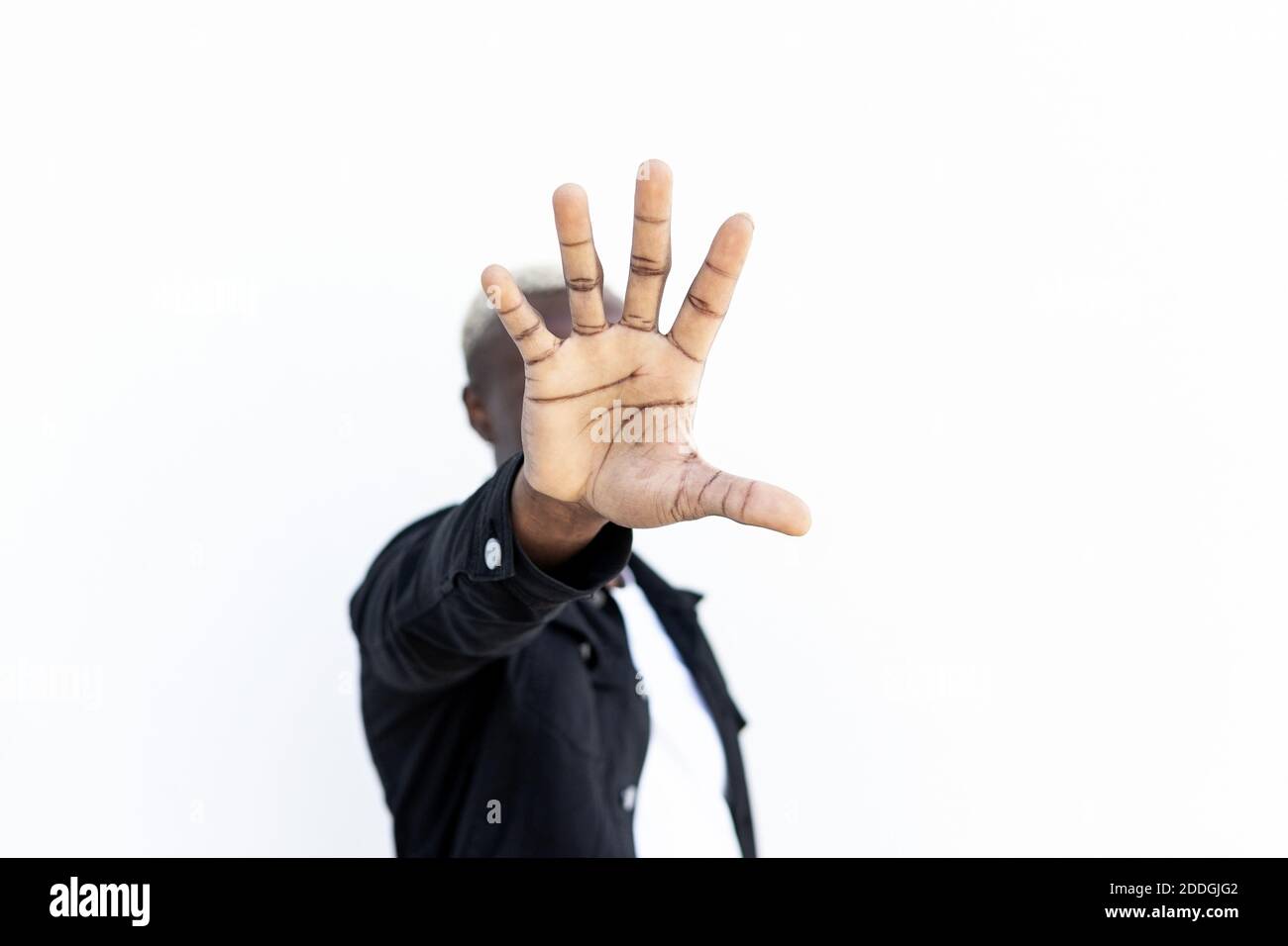 Anonymous African American male in casual outfit reaching hand toward ...