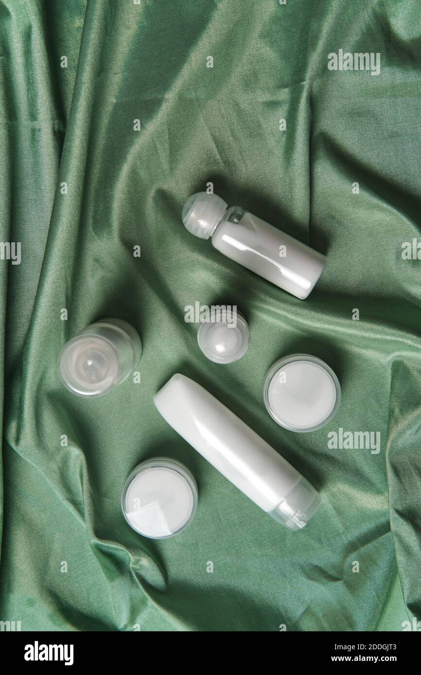 Focused young Asian male in sportswear stretching legs near metal ...