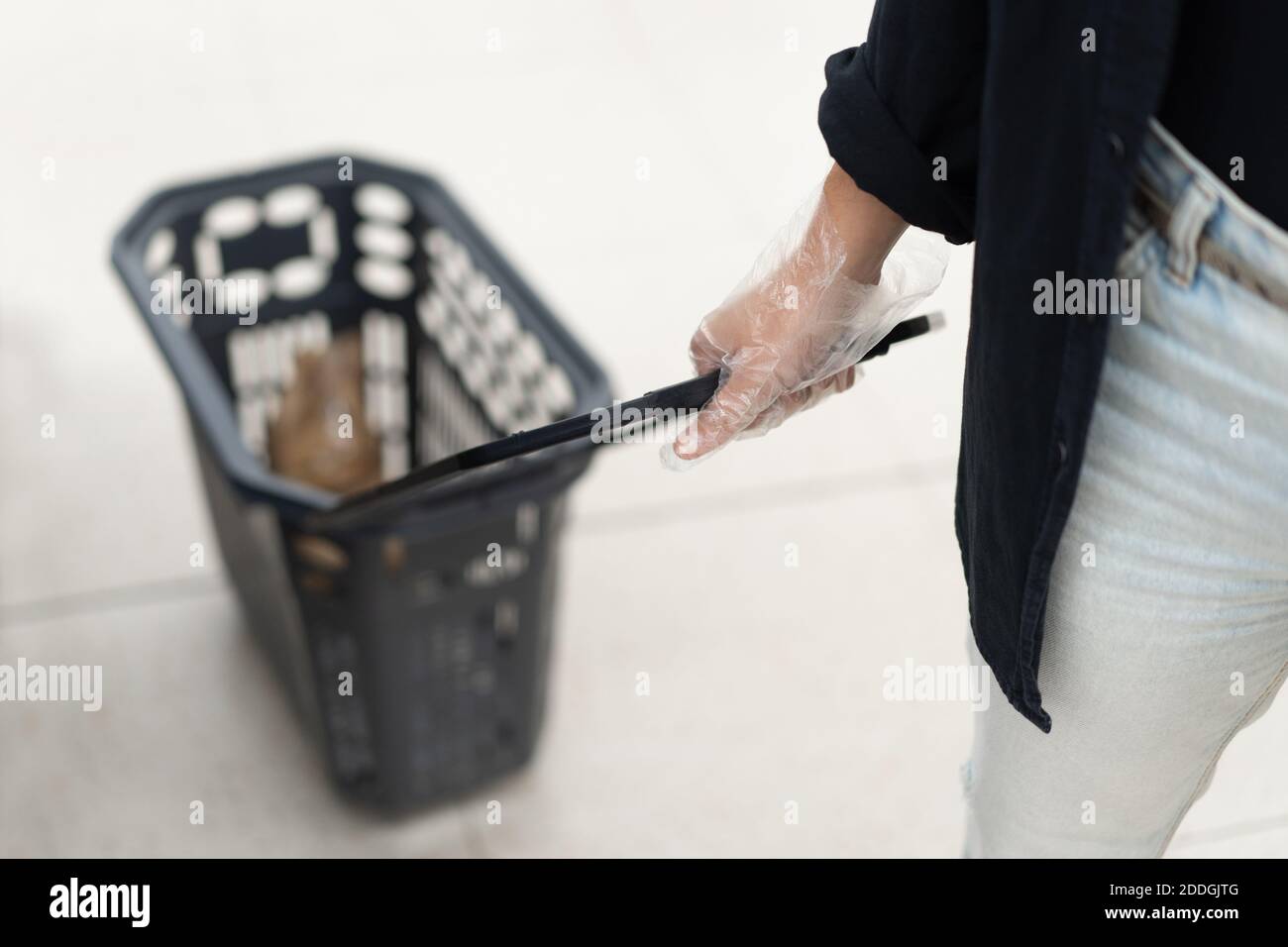 From above of crop unrecognizable female buyer in cellophane gloves ...